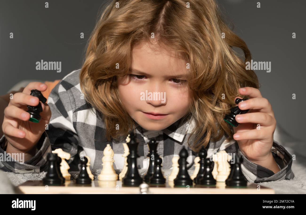 Clever thinking child. Kid playing chess. Clever child thinking about ...