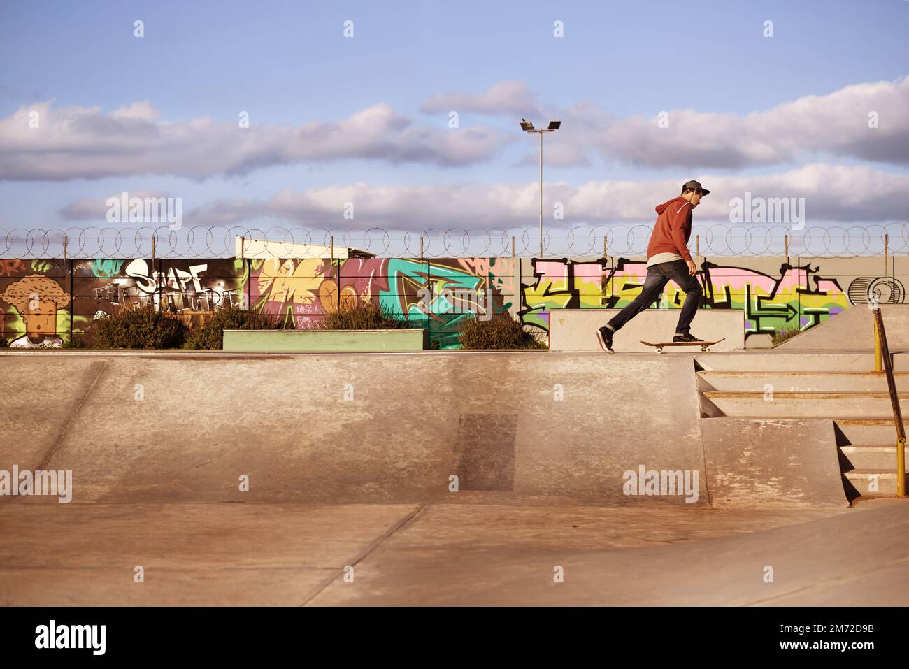 Skate culture. A full length shot of a young man skating at a skate ...