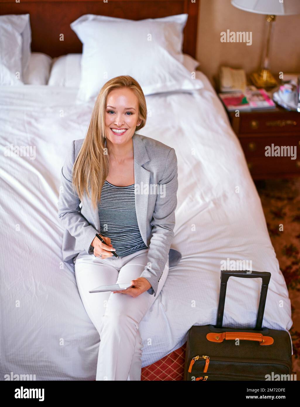 Booked in for business. A businesswoman relaxing in a hotel room Stock ...
