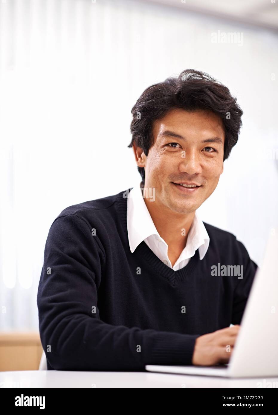Asian male in a suit smiling hi-res stock photography and images - Alamy