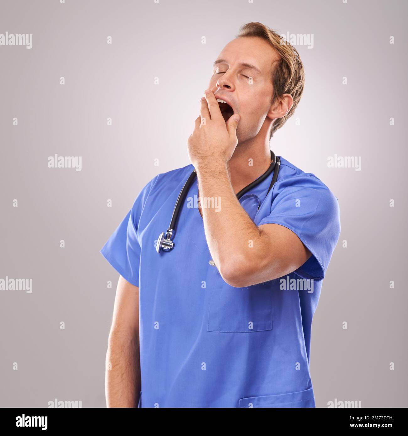 Sleepy after a long surgery. Cropped studio shot of a handsome male ...