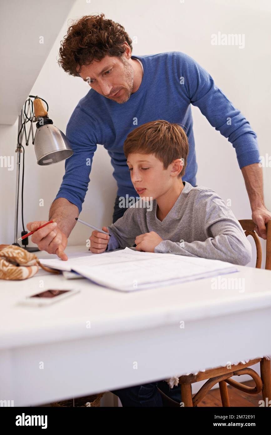 When in doubt, ask Dad. a teenage boy getting some study help from his ...