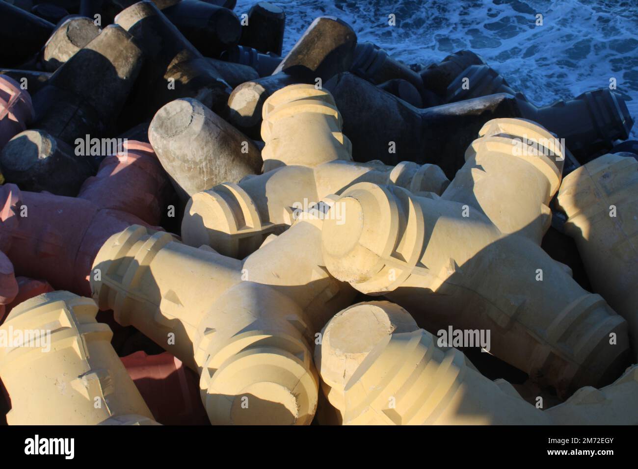Colorful jetty stones on beach Stock Photo - Alamy