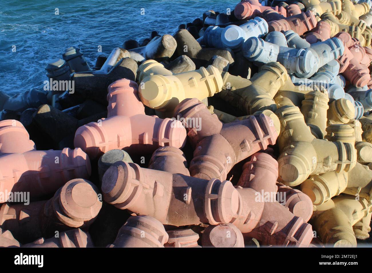 Colorful jetty stones on beach Stock Photo - Alamy