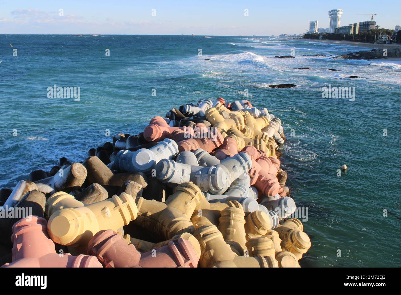 Colorful jetty stones on beach Stock Photo - Alamy
