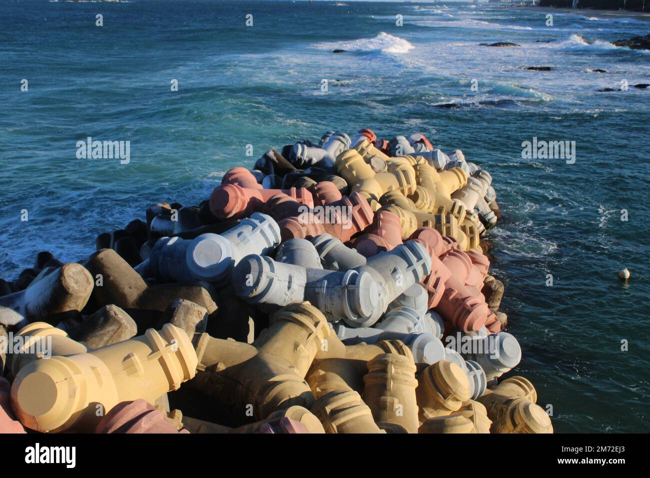 Colorful jetty stones on beach Stock Photo - Alamy