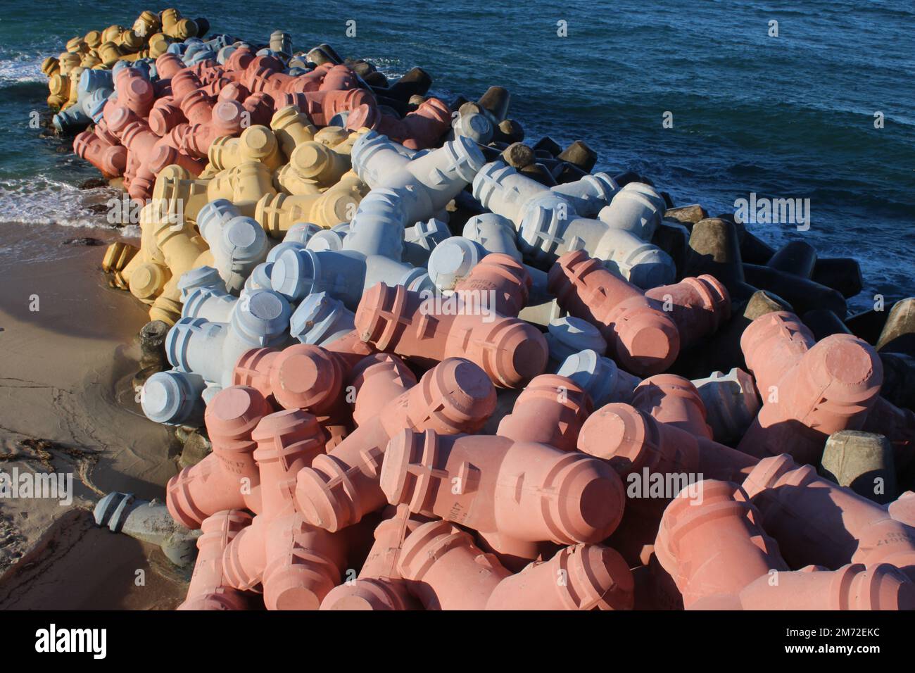 Colorful jetty stones on beach Stock Photo - Alamy