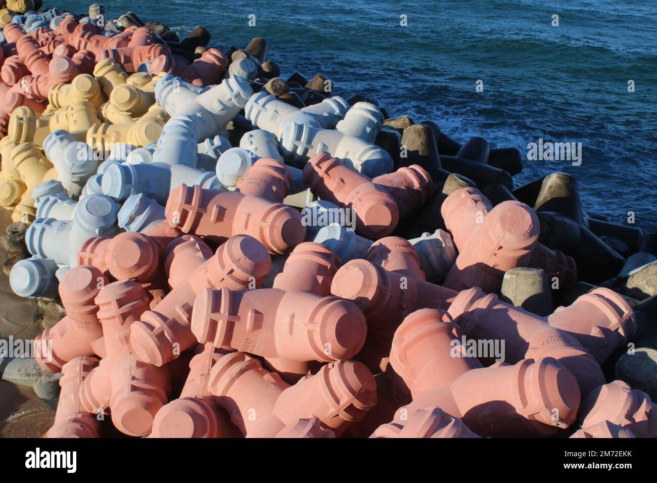 Colorful jetty stones on beach Stock Photo - Alamy