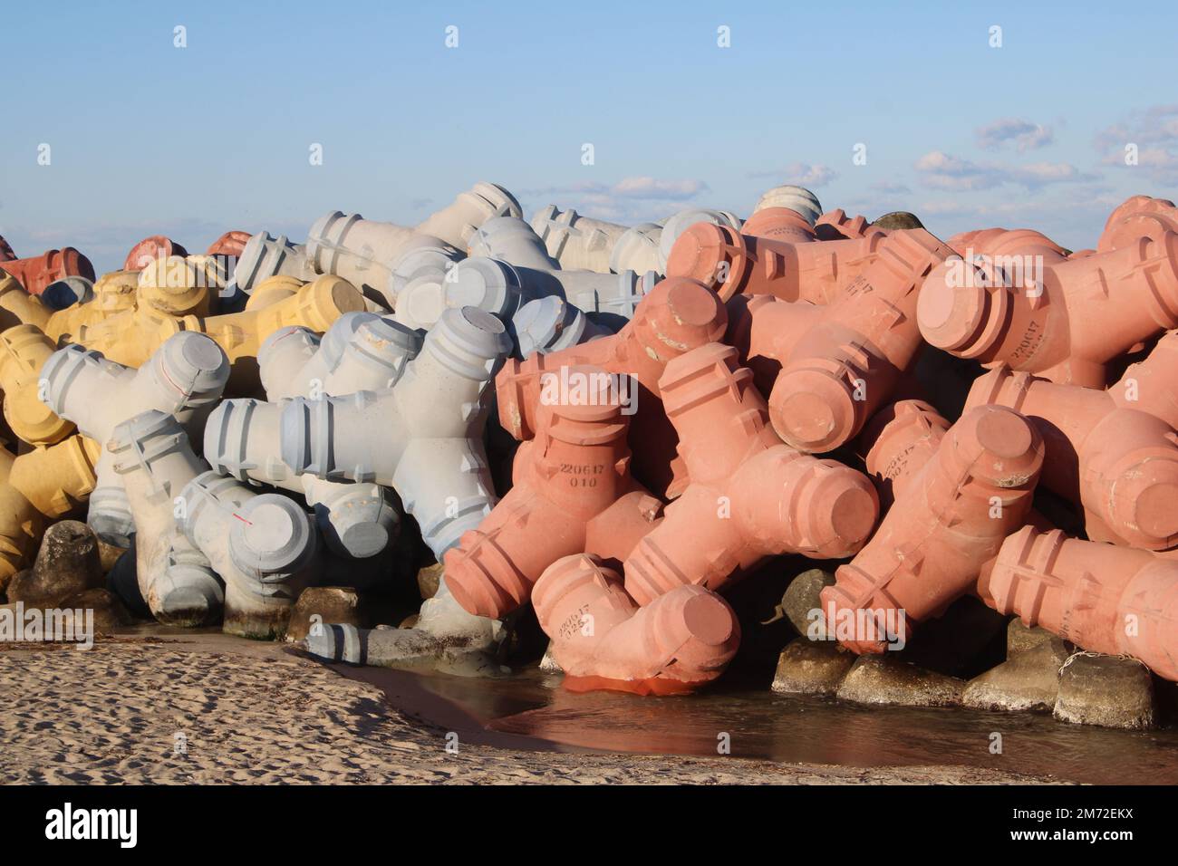 Colorful jetty stones on beach Stock Photo - Alamy