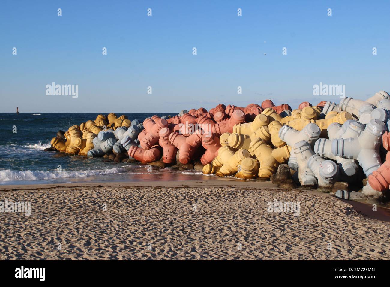 Colorful jetty stones on beach Stock Photo - Alamy