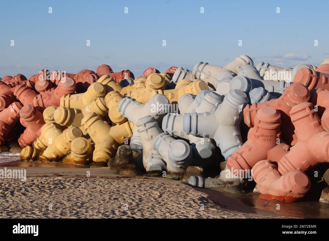 Colorful jetty stones on beach Stock Photo - Alamy