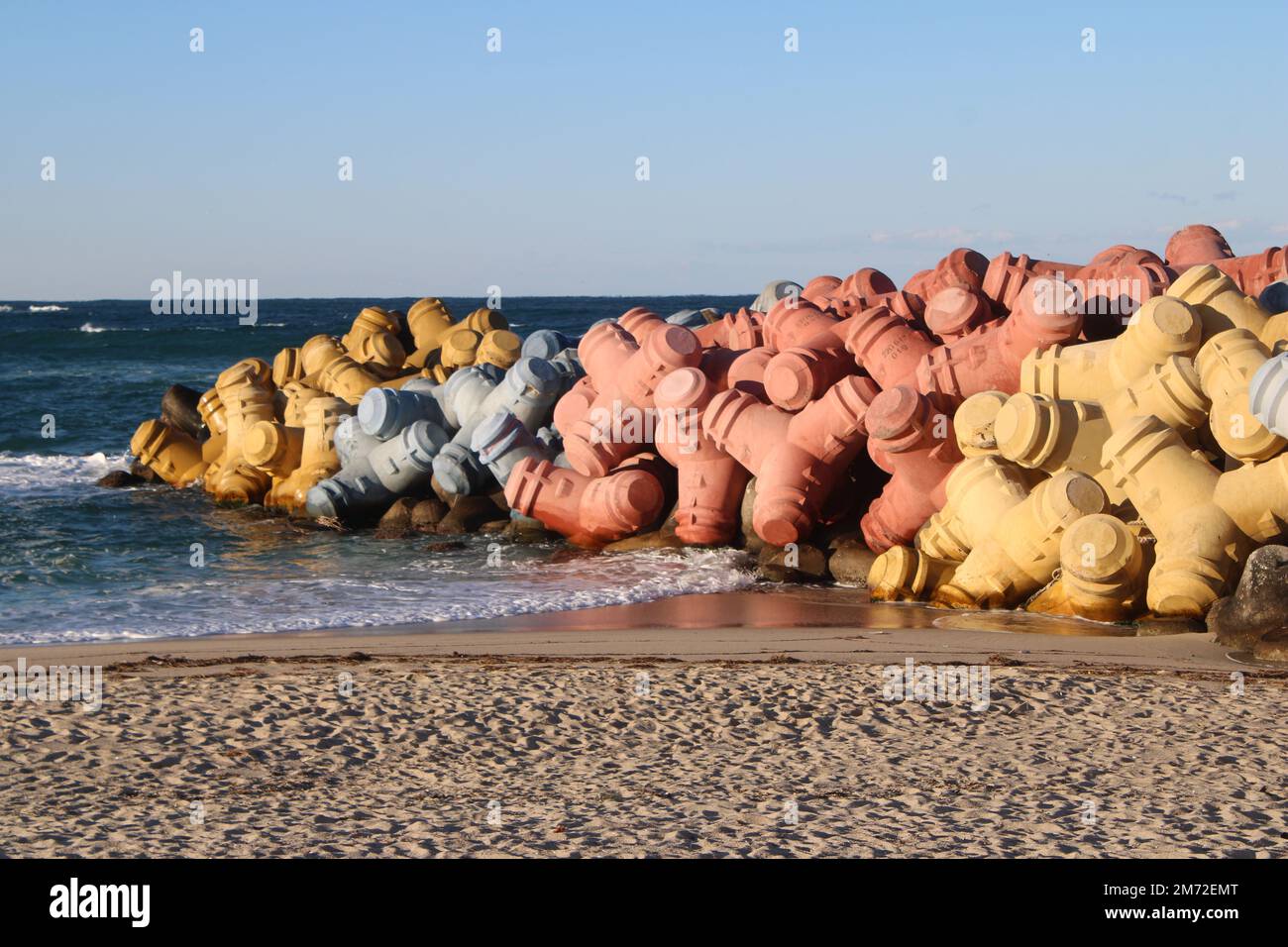 Colorful jetty stones on beach Stock Photo - Alamy