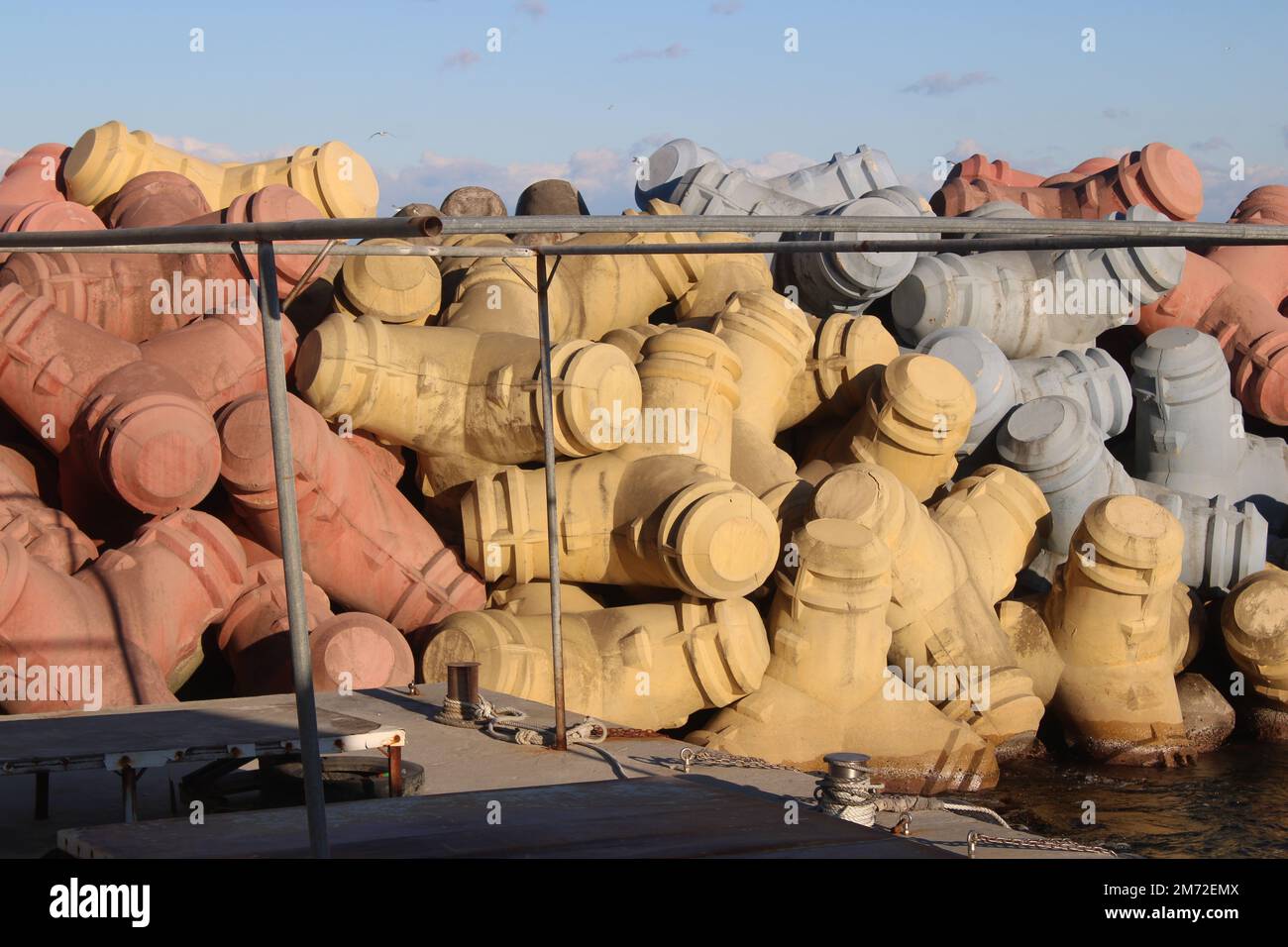 Colorful jetty stones on beach Stock Photo - Alamy