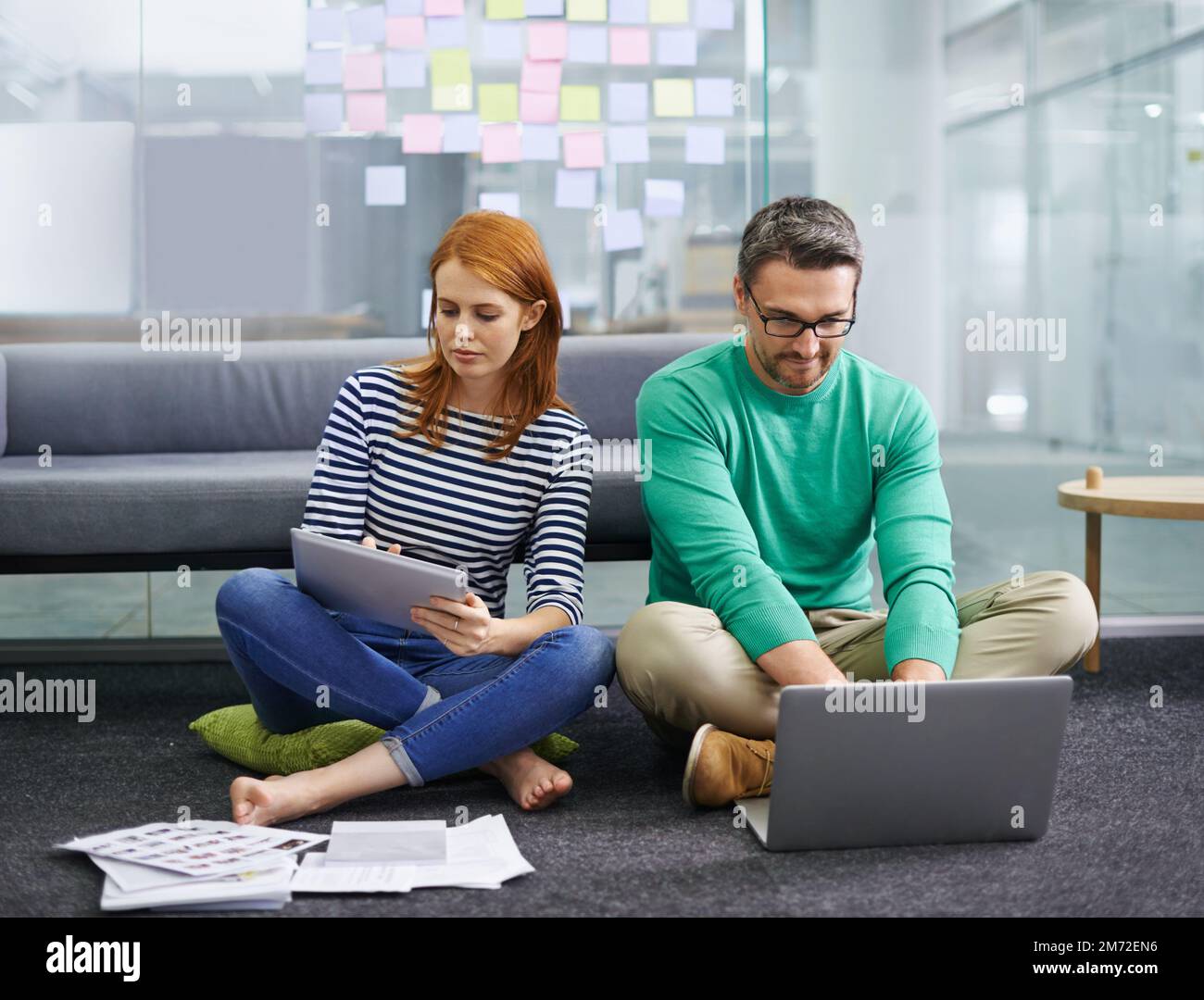 Researching for business is fun. Two work colleagues using technology ...