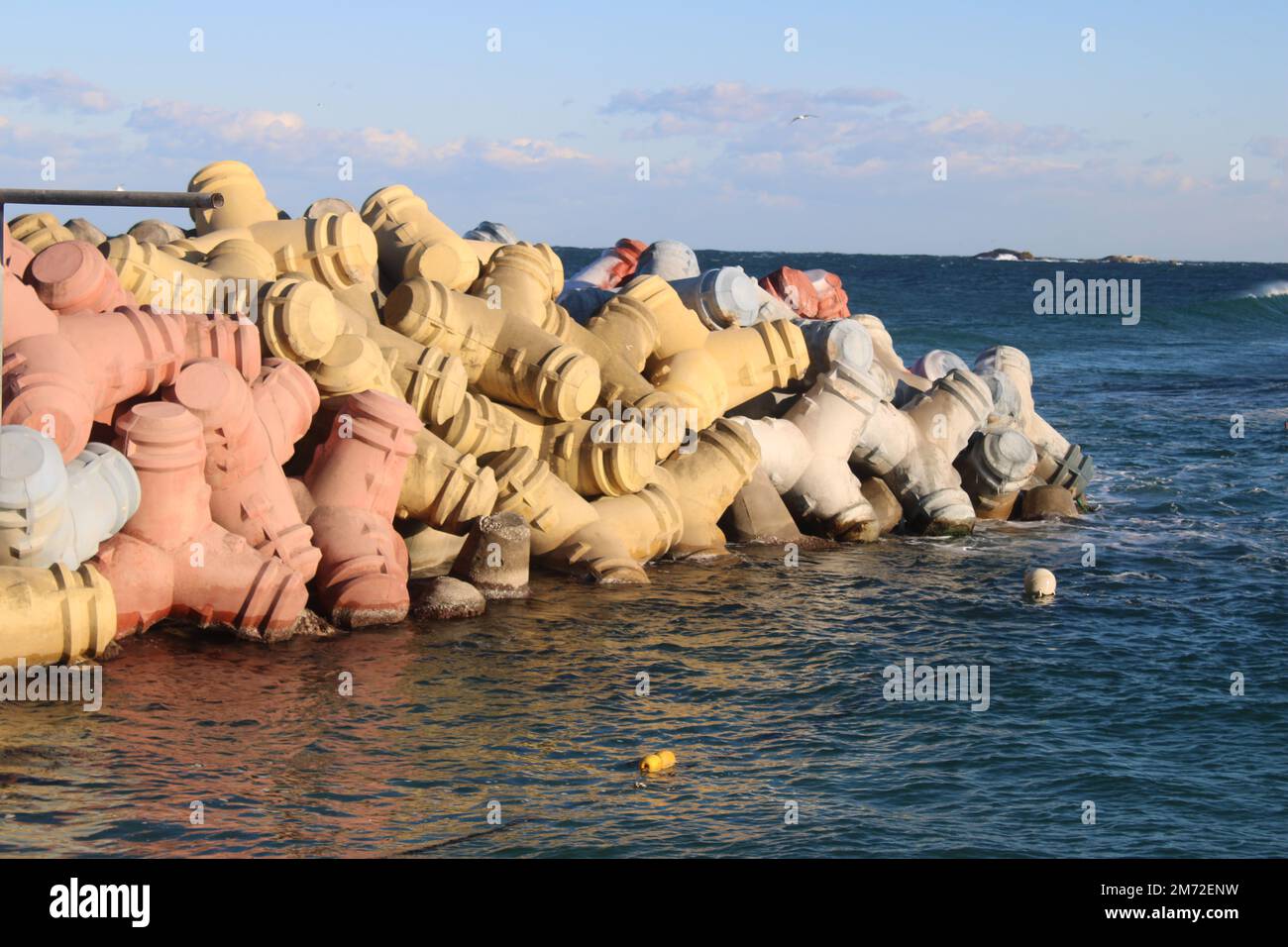 Colorful jetty stones on beach Stock Photo - Alamy