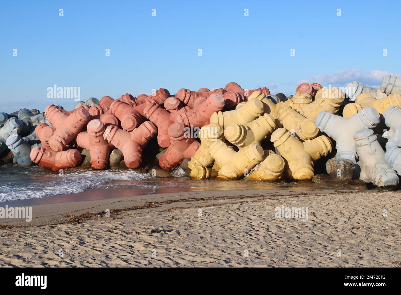 Colorful jetty stones on beach Stock Photo - Alamy
