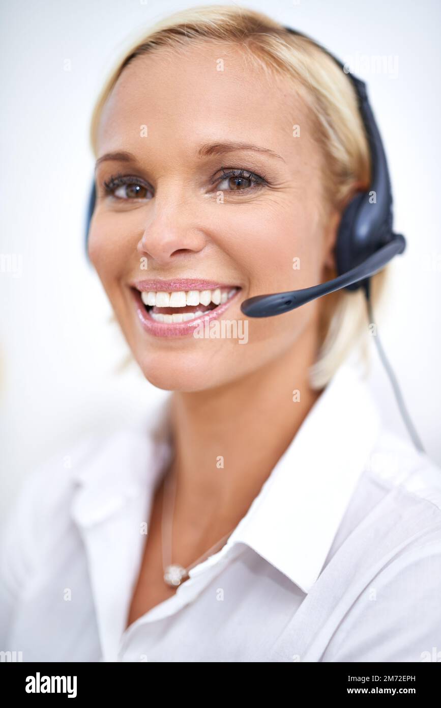 Happy to help. Portrait of an attractive young call center agent ...
