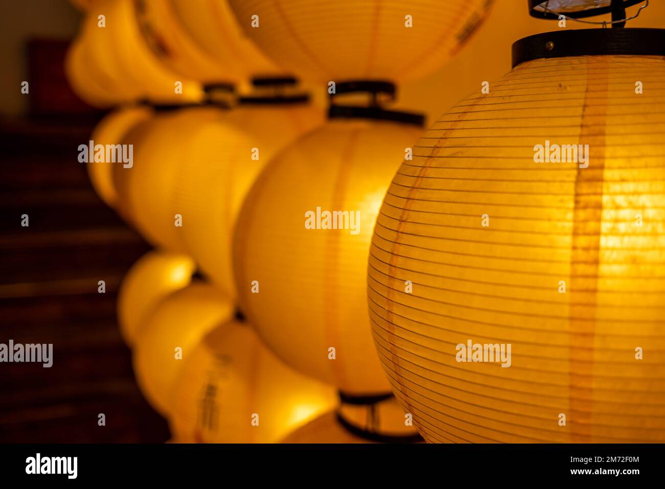 Yellow Chinese lanterns hanging in a row Stock Photo - Alamy