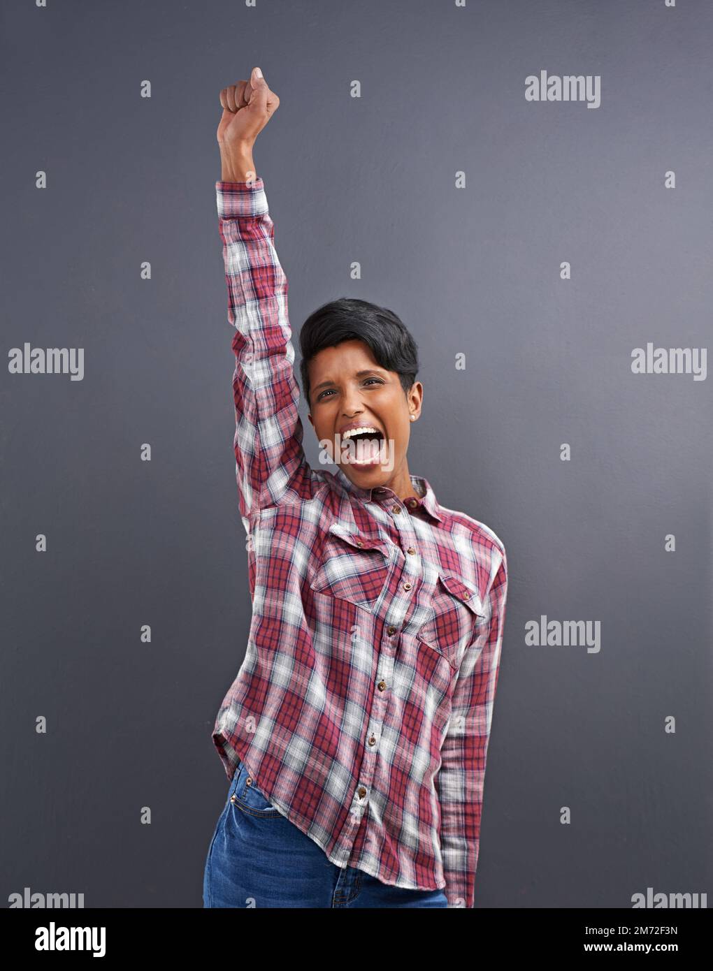 Im number one baby. Studio shot of a beautiful young woman cheering ...
