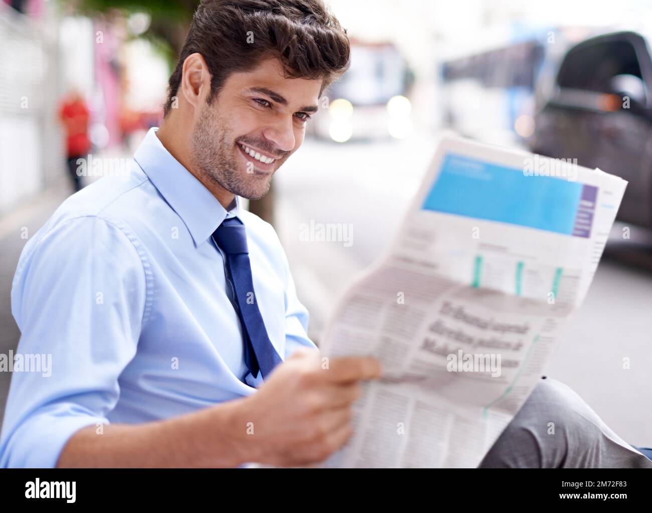 Straight to the business section. A handsome young businessman reading ...