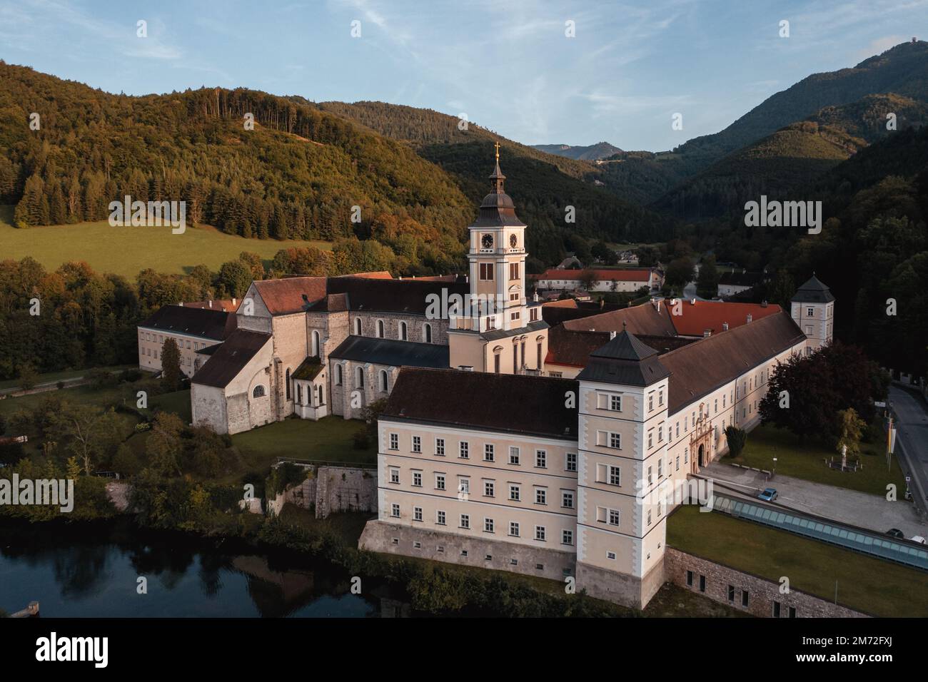 An aerial drone view of Lilienfeld Abbey in Austria during the sunset ...