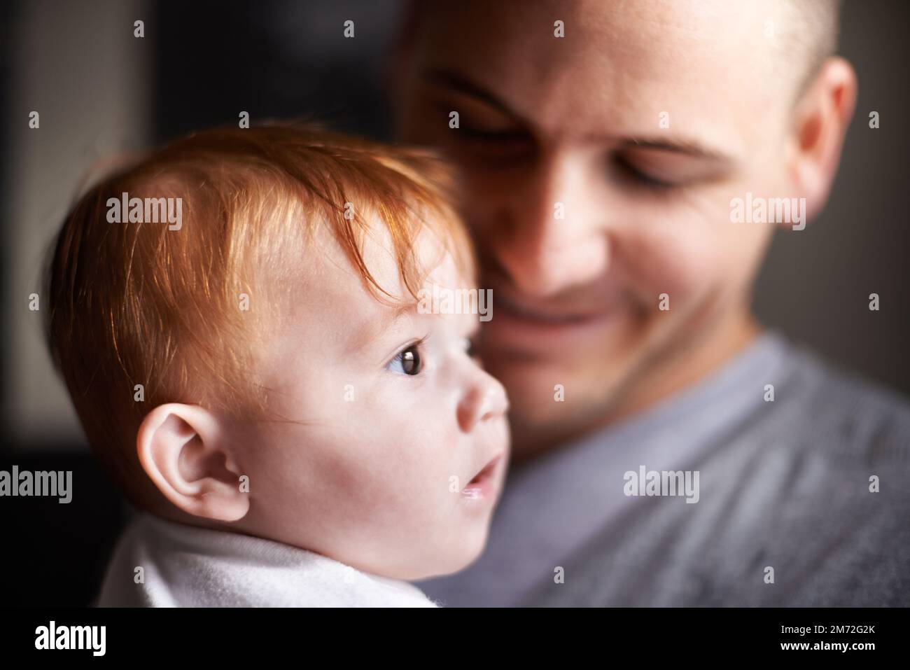 Hes a dedicated dad. Closeup shot of an adorable baby girl being held ...