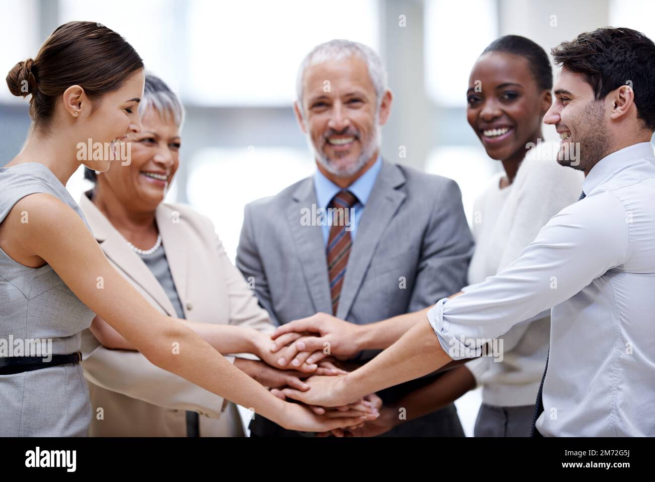 Building something better as a team. a group of businesspeople putting ...