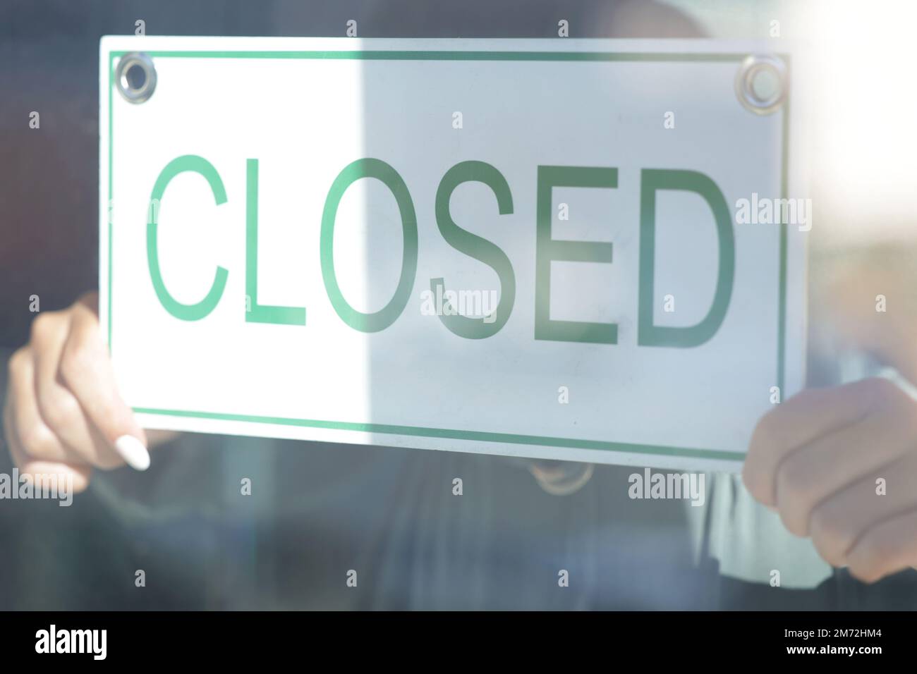 Closed, sign and window with a small business owner or entrepreneur ...