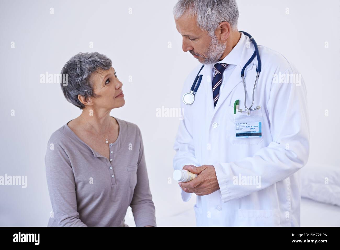 Follow these directions to get better. a mature doctor explaining ...