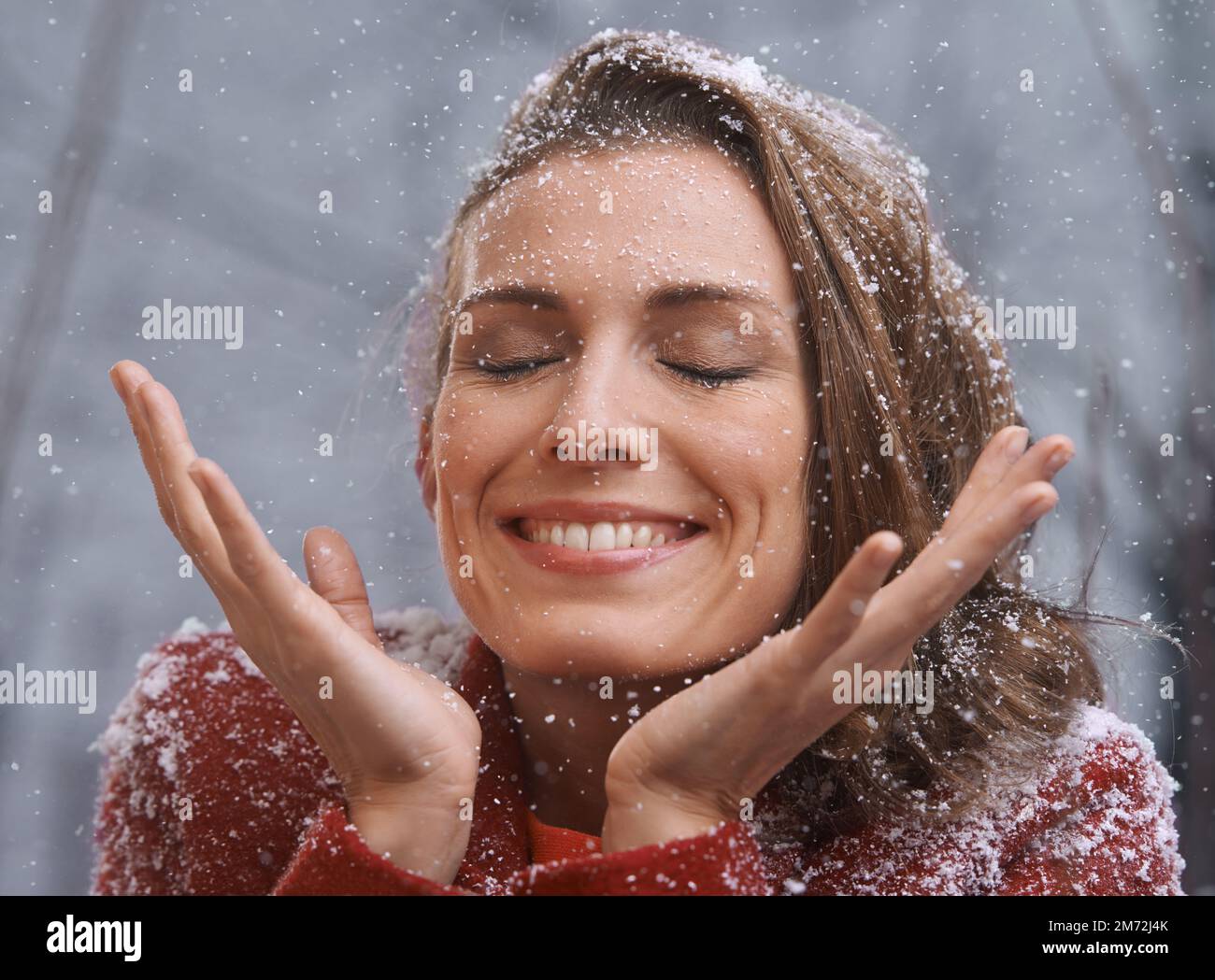 Braving the outdoors isnt all bad. a woman closing her eyes in the snow ...