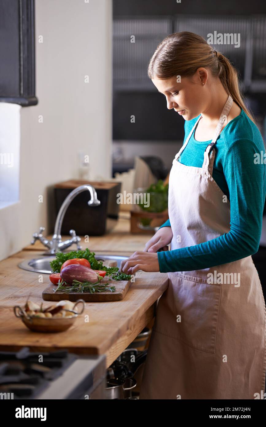 Getting things done chop-chop. an attractive young woman chopping ...