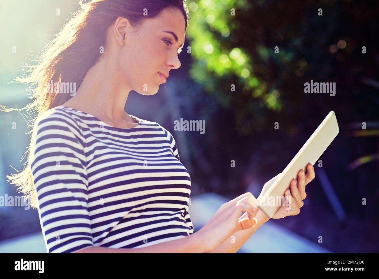 Instant access to the online world. a beautiful young woman using a ...