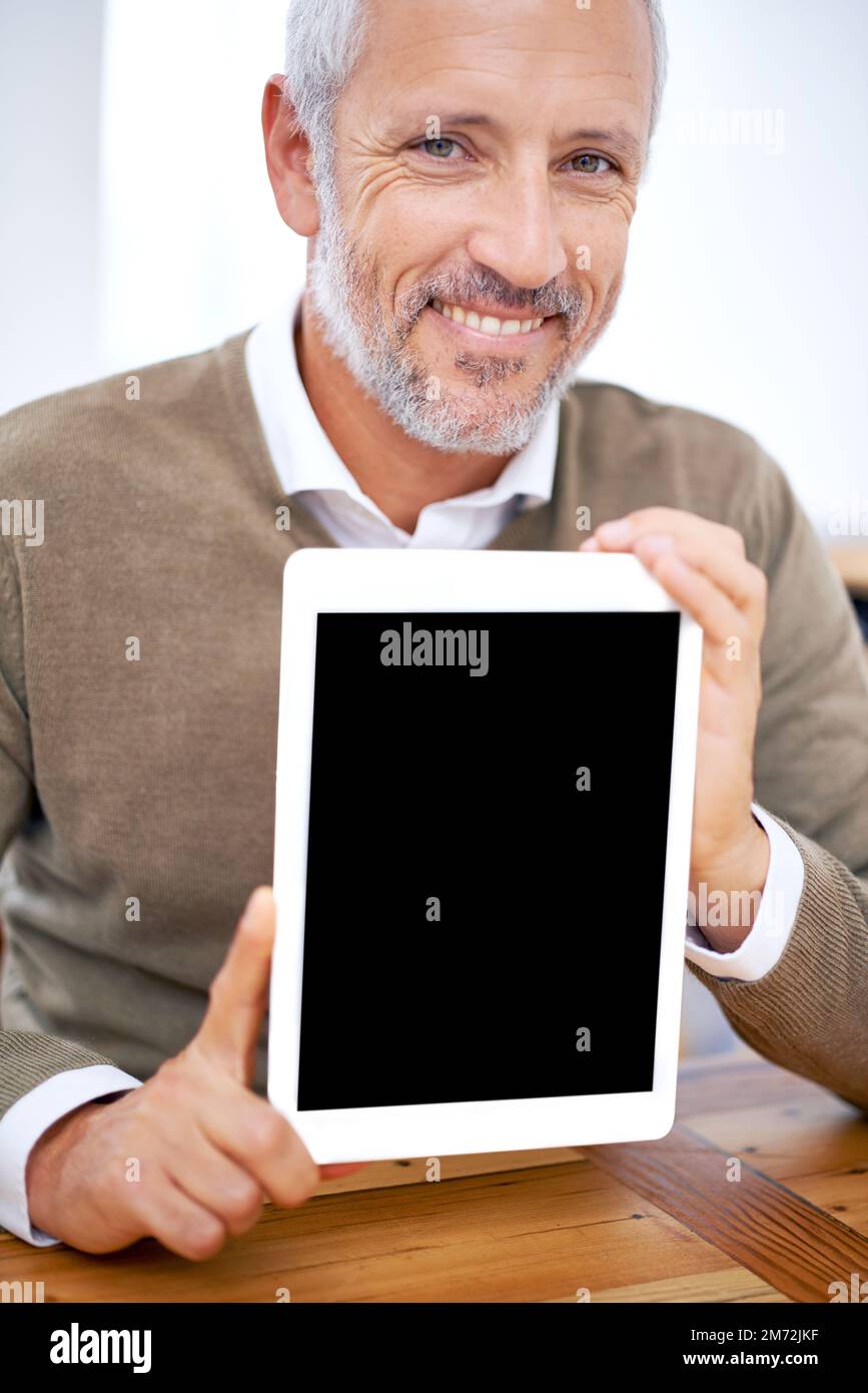 I like this app. A cropped portrait of a happy businessman showing a ...