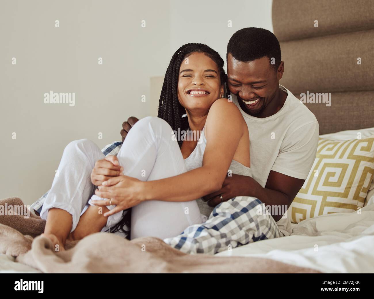 Love, black couple on bed and play together for bonding, loving and ...