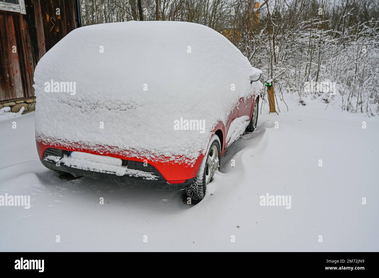 red car covered in snow Sweden january 6 2023 Stock Photo - Alamy