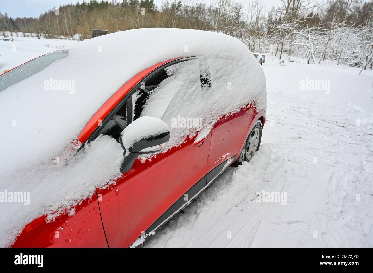 red car covered in snow Sweden january 6 2023 Stock Photo - Alamy