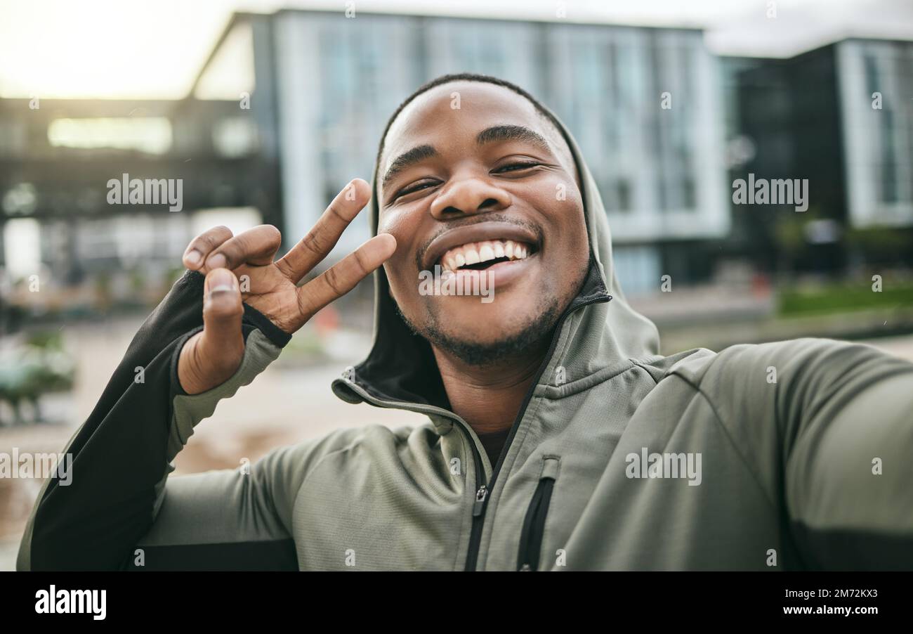 Fitness, selfie and man with peace sign in the city while doing a ...