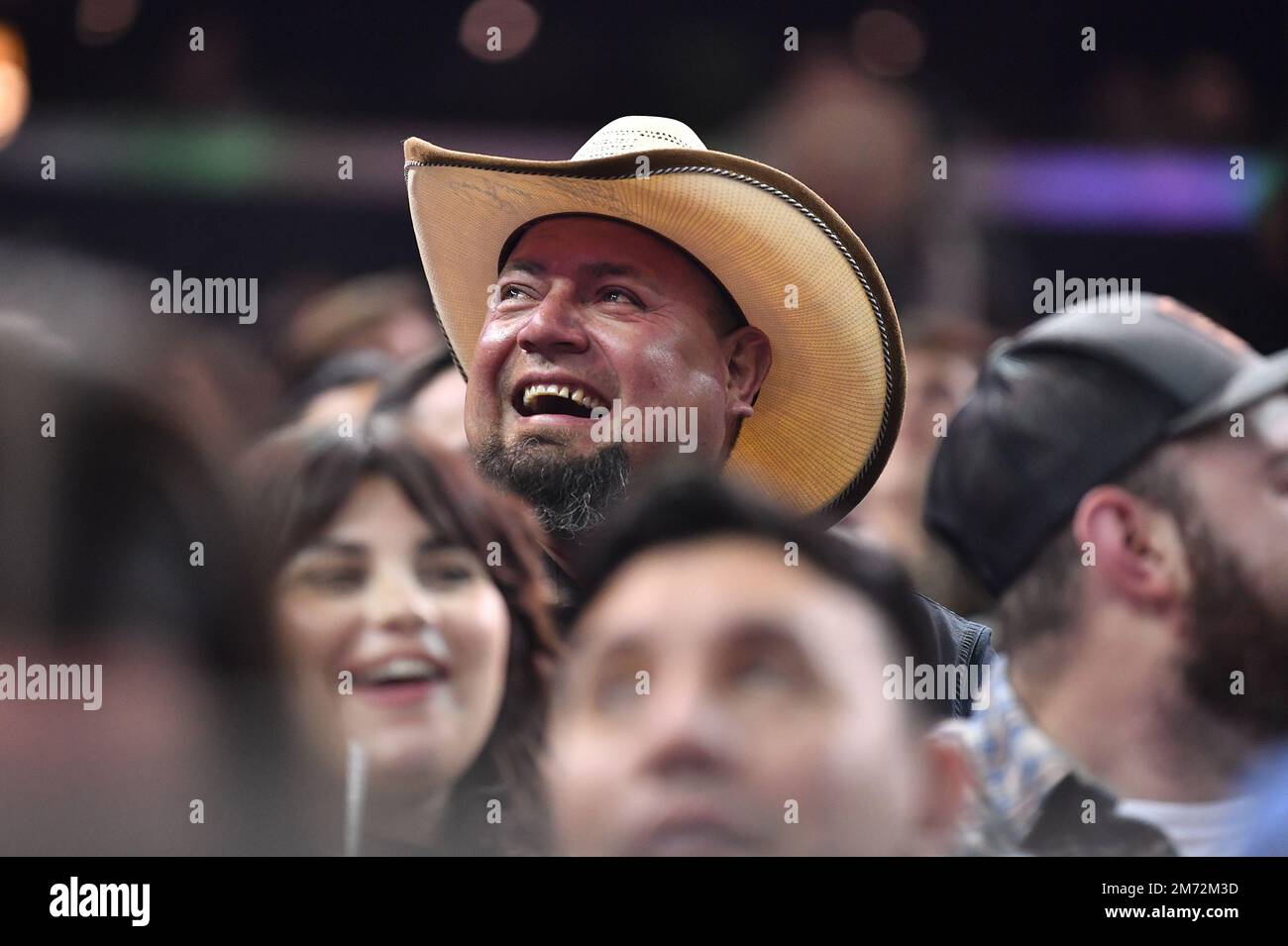 A man wearing a cowboy hat smiles as he attends the PBR Monster Energy ...