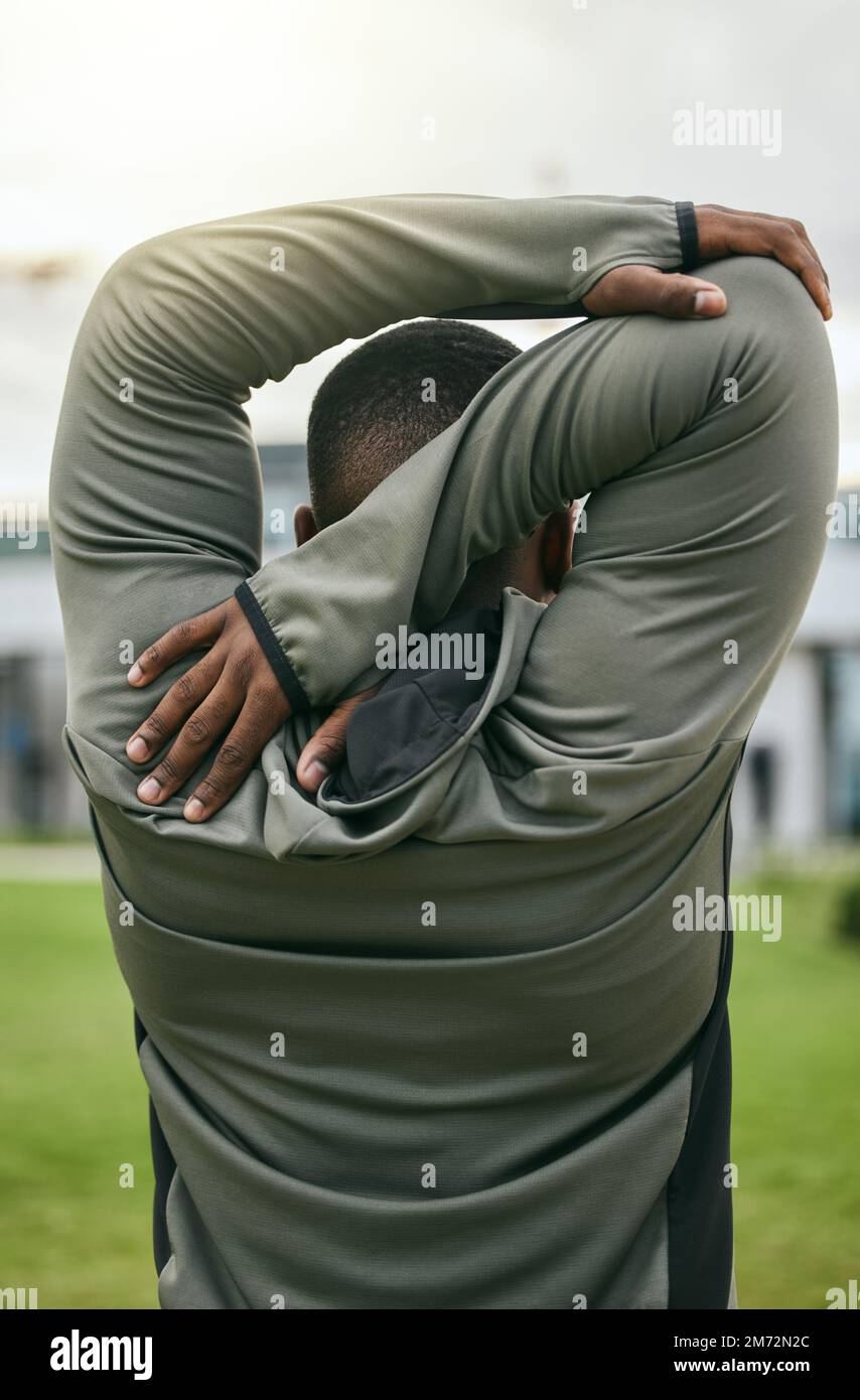 Fitness, back and stretching with a sports black man outdoor for a warm ...