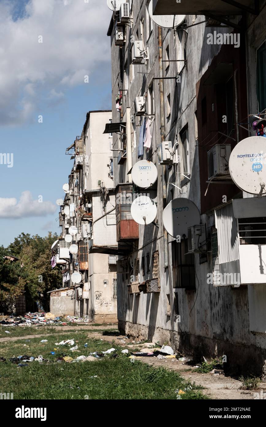 A vertical shot of apartment buildings with satellite dishes in ...