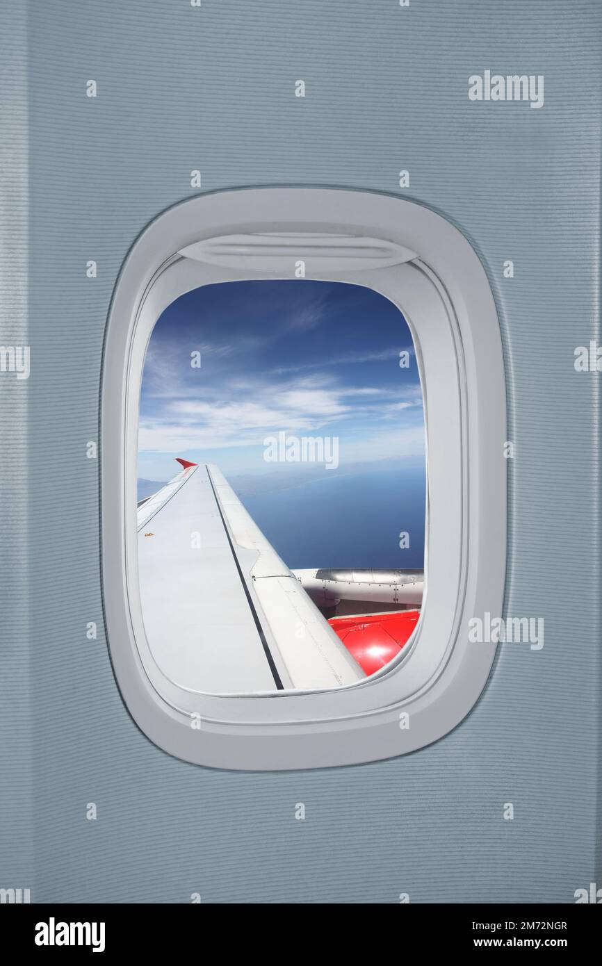 Airplane window with flying view Stock Photo - Alamy