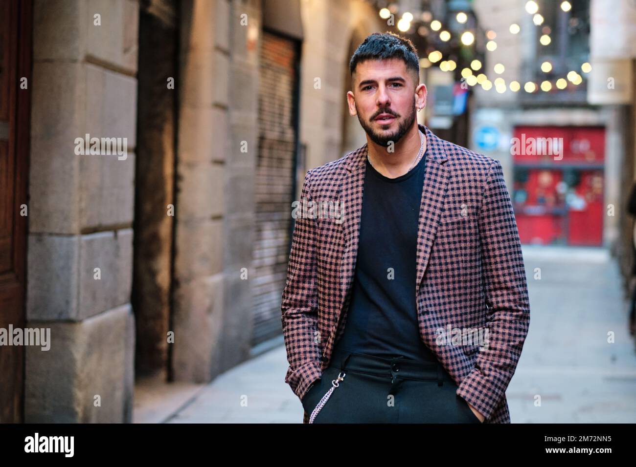 Beautiful man looking at the camera while posing outdoors Stock Photo ...