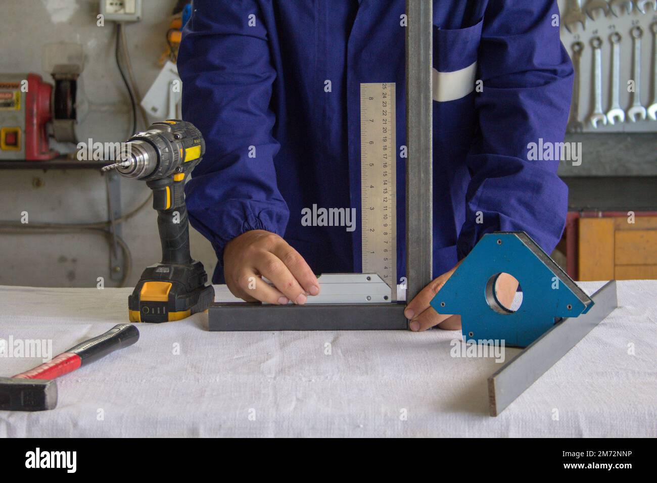 a metalworker in the workshop who finds the precise angle of a ...