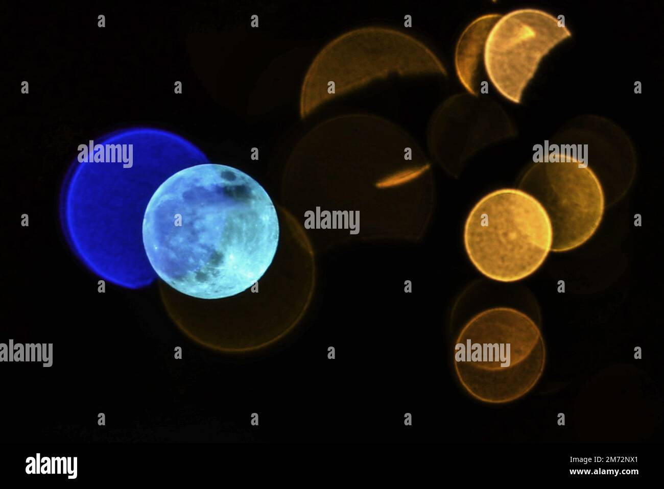 Full moon known as a “Wolf Moon” hidden among Christmas lights in ...