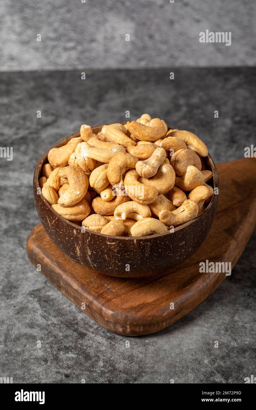 Cashew nuts on dark background. Fresh cashews in coconut bowl. Studio ...