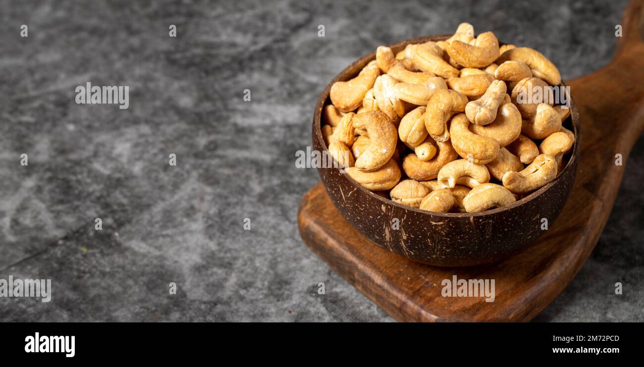 Cashew nuts on dark background. Fresh cashews in coconut bowl. Studio ...
