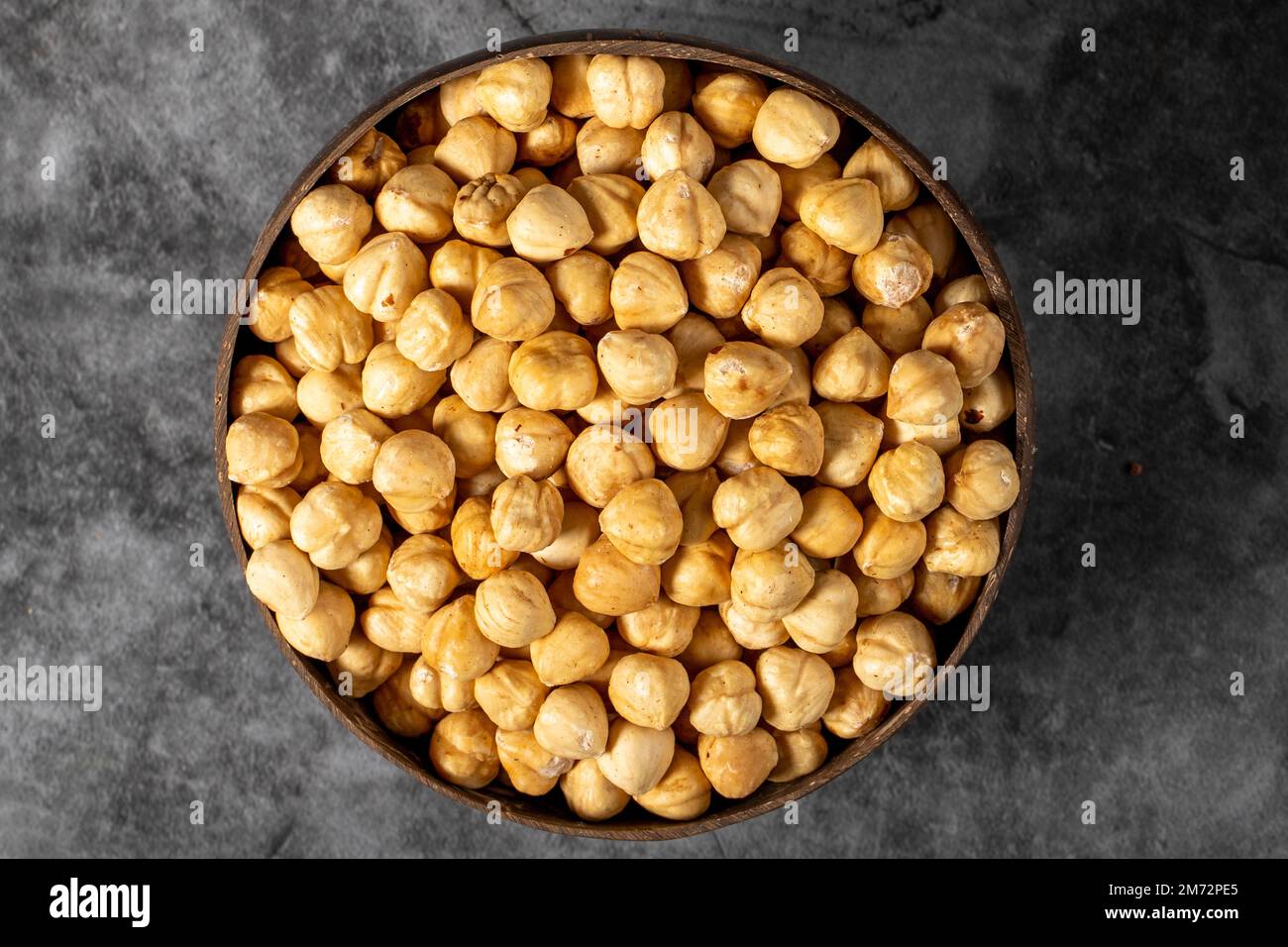 Roasted hazelnut nuts on dark background. Fresh hazelnuts in a coconut ...