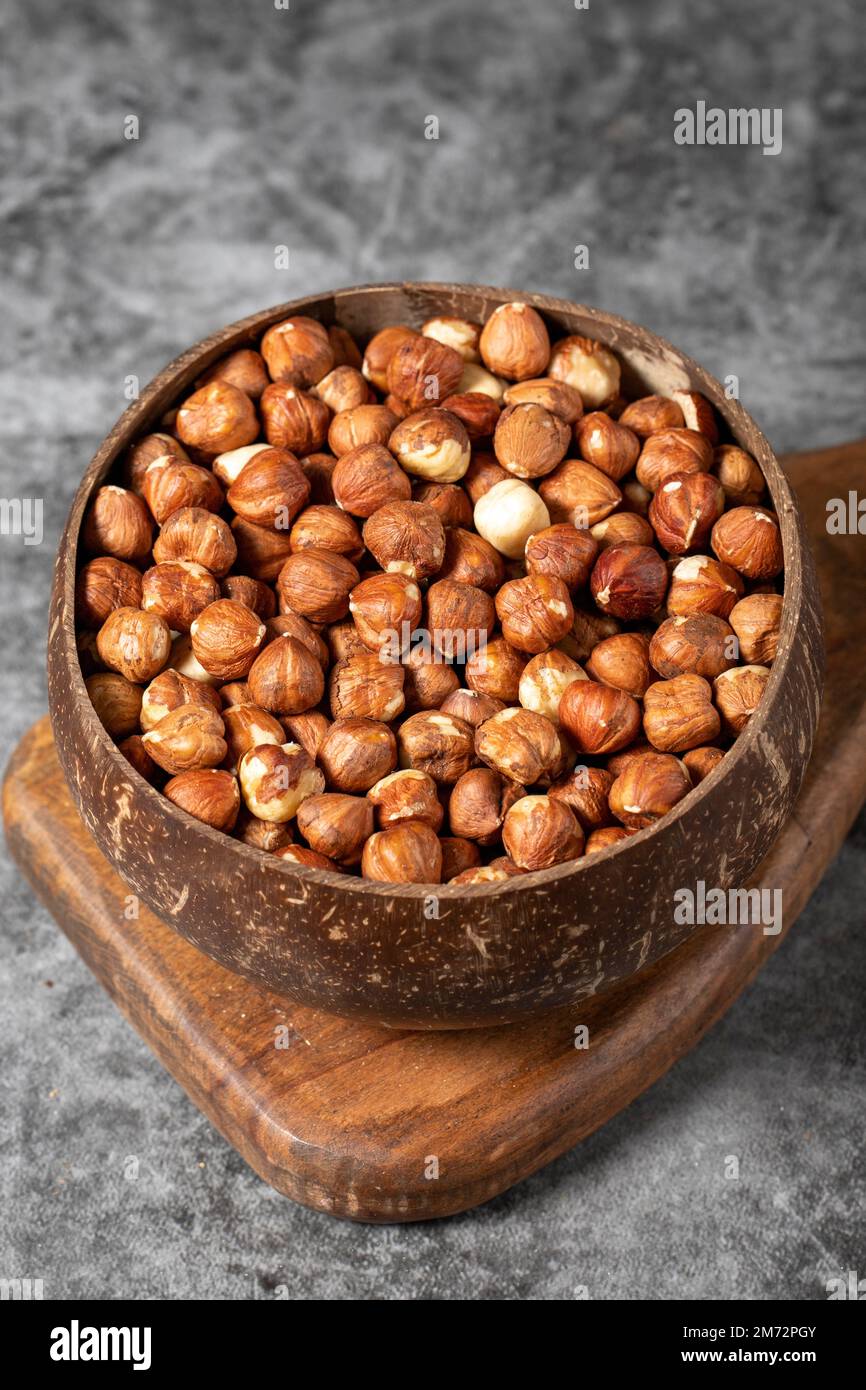 Fresh hazelnut nuts on dark background. Nuts in a coconut bowl. Studio ...