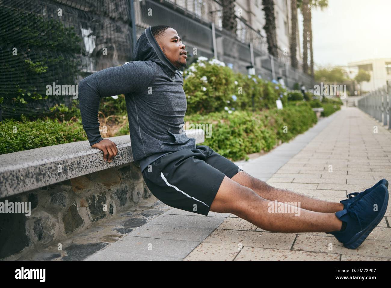 Exercise, triceps dips and black man in city, street or outdoors ...