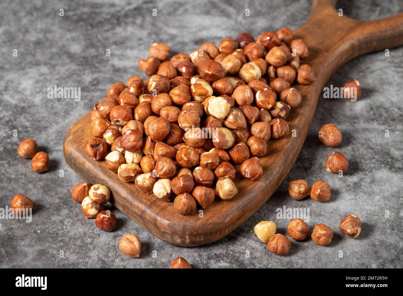 Nuts on a wood serving board. A pile of nuts. Studio shoot. close up ...